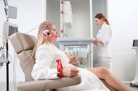 Female Diagnostician Performs Electroencephalogram Procedure On Patient Stock Image Image Of