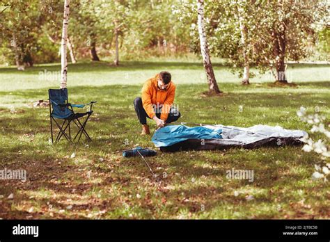 Man Setting Up Tent Outdoors Stock Photo Alamy