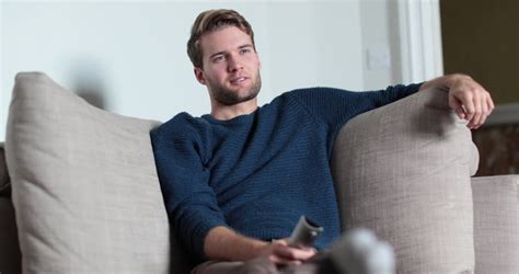 Upset Man In His Forties S In Bed Looking Down At His Penis Under White Covers Sheet In