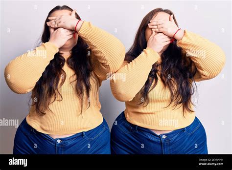 Young Plus Size Twins Wearing Casual Clothes Covering Eyes And Mouth With Hands Surprised And