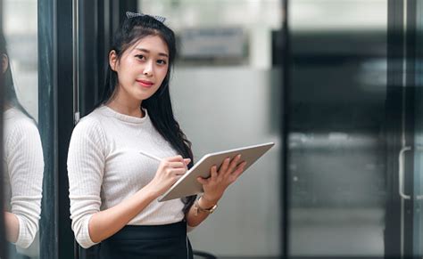 현대식 방에 태블릿을 들고 미소를 지으며 카메라를 바라보는 자신감 있는 여성의 초상화 20 29세에 대한 스톡 사진 및 기타 이미지 20 29세 기업가 디지털 태블릿