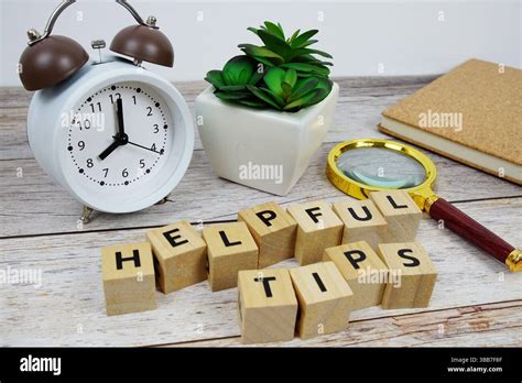Magnifying Glass And Alarm Clock With Wooden Blocks Alphabet Letters Helpful Tips Text Message