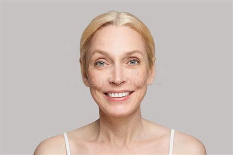 Portrait Of Happy Blonde Mature Woman With Shiny Skin With Mimic