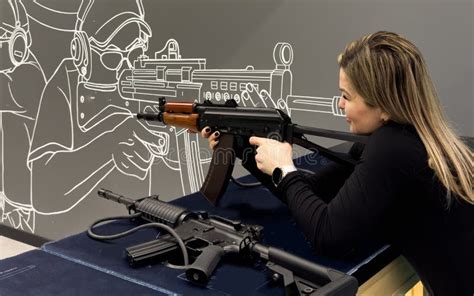 Girls With A Rifle At A Shooting Range Near The Target High Quality