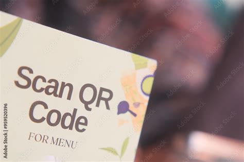 Woman Hand Using The Smart Phone To Scan The Qr Code To Select Food Menu In The Restaurant Stock