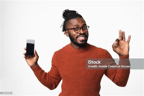 아프리카 계 미국인 젊은 사업가 프리랜서 복사 공간 여유 공간을위한 화면이있는 휴대 전화 스마트 폰을 들고 흰색 배경에 고립 된 온라인 확인 제스처로 모바일 응용 프로그램을