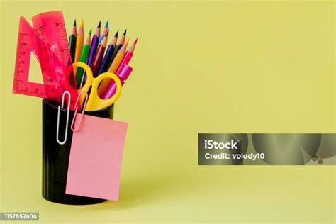 텍스트 공간이 있는 학교 개념으로 돌아갑니다 공간을 복사합니다 학교 사무용품 다채로운 문구가 있는 창의적인 책상 컬러 종이 클립입니다 노란색 배경에 학교 용품 오피스 데스크