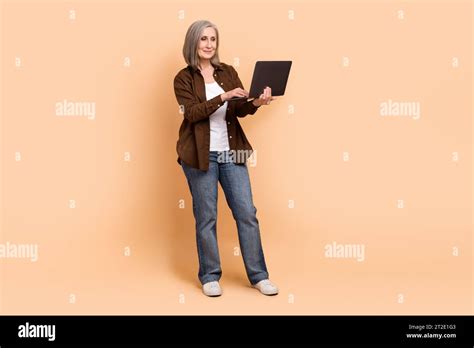 Full Size Body Cadre Of Confident Programmer Old Woman Coding Devops Use Netbook Wear Jeans