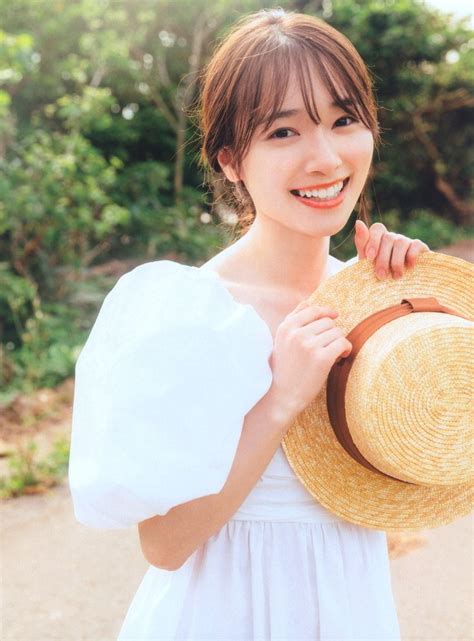 A Woman In White Dress Holding A Straw Hat