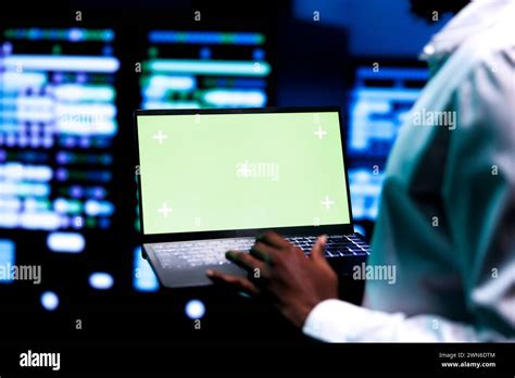 Computer Scientist Using Green Screen Laptop To Verify Configuration
