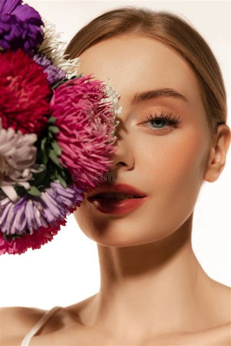 Attractive Blond Girl With Big Beautiful Bouquet Of Flowers On White