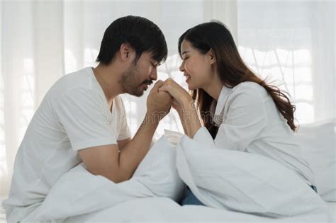 Asian Romantic Couple In Bed Enjoying Sensual Foreplay Happy Sensual Young Couple Lying In Bed