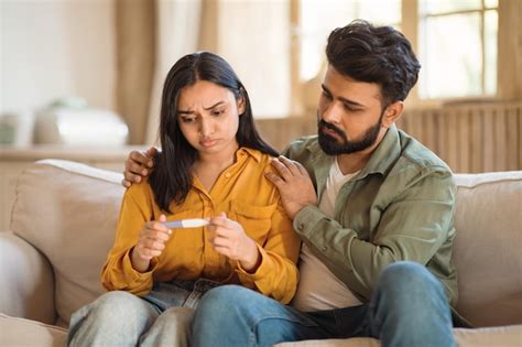 Infertility Unhappy Young Indian Couple Holding Negative Pregnancy Test