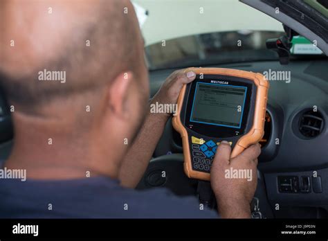 Auto Mechanic Checking Engine Using Scanning Device Stock Photo Alamy