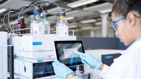Scientist In A Lab Looks At The Screen For The Infinitylab Assist Ui