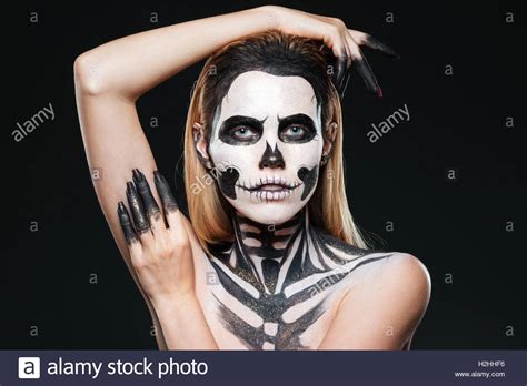 Portrait Of Girl With Scared Skeleton Makeup Over Black Background