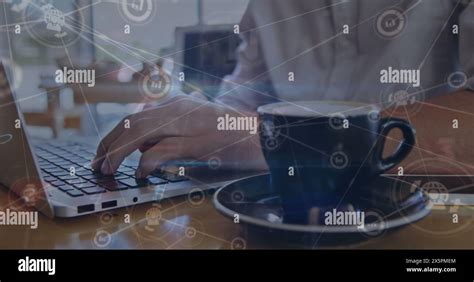 Image Of Cyber Security Data Processing Over Mid Section Of A Man Using Laptop At A Cafe Stock