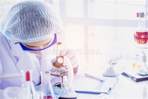 Female Scientist Look At Microscope Science Test Tube Analyse Scientific Sample In Laboratory