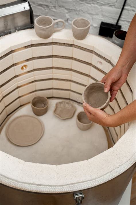 The Process Of Firing Clay Products Placing Pottery In A Muffle