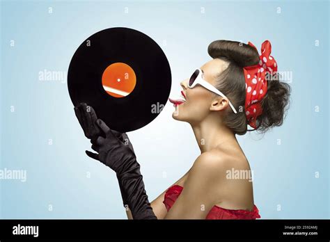 A Photo Of A Glamorous Pin Up Girl Touching A Vinyl Lp With Her Tongue