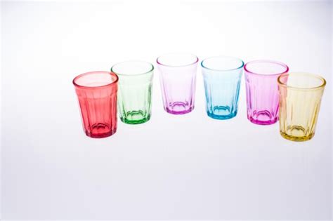 Premium Photo Close Up Of Multi Colored Glasses Against White Background