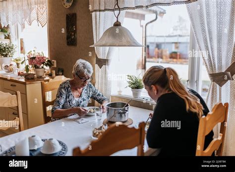 Grandmother And Adult Granddaughter Eating At Home Stock Photo Alamy