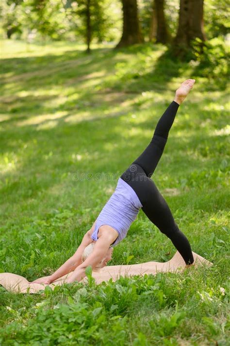 Middle Age Athletic Attractive Woman Practicing Yoga Doing Yoga In