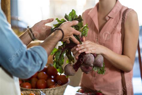 Female Customer Purchasing Beetroot From The Vendor At The Supermarket Photo Background And
