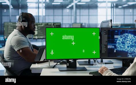 It Support Workers In Ai Data Center Coding On Green Screen Computers Upgrading Equipment