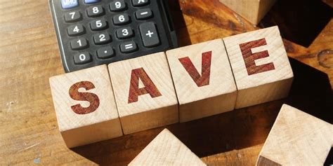 Premium Photo Word Save Save Text On Wooden Blocks And Calculator Business Concept Image