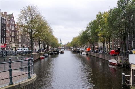 Premium Photo A Canal With A Green Roof And A Building In The Background