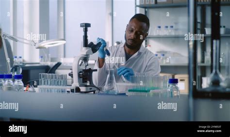 Medical Science Lab African American Microbiologist Takes Liquid From