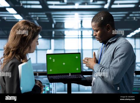 Engineers In Data Center Using Isolated Screen Notebook Observing