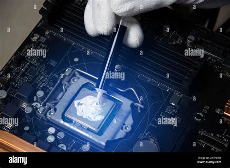 The Technician Is Adding Thermal Silicone To The CPU Chip Stock Photo Alamy
