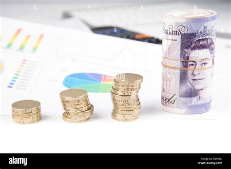 British Pound Coins And Notes With Financial Chart Stock Photo Alamy