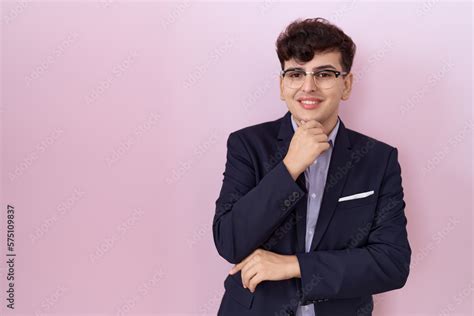 Young Non Binary Man With Beard Wearing Suit And Tie Looking Confident At The Camera Smiling