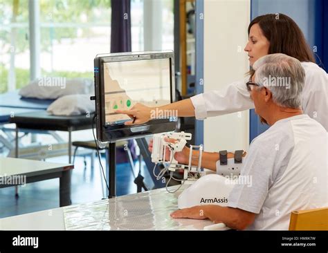 Therapist And Patient With Assistive Robot For Upper Limb Rehabilitation The Robot Armassist