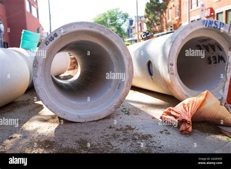 New Concrete Sewer Pipes Are Laying On The Road To Be Installed At