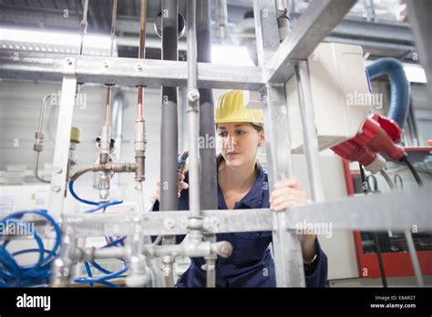 Female Engineer Checking Factory Pipes Stock Photo Alamy