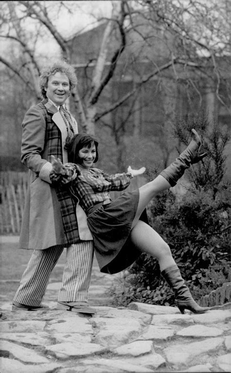 An Old Black And White Photo Of Two People Posing For The Camera With Their Legs In The Air