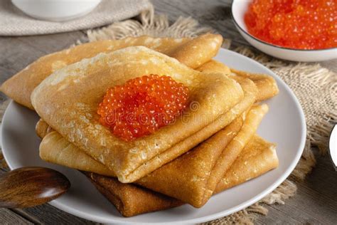 Stack Of Russian Thin Pancakes Blini With Red Caviar On An Old Wooden Table Maslenitsa