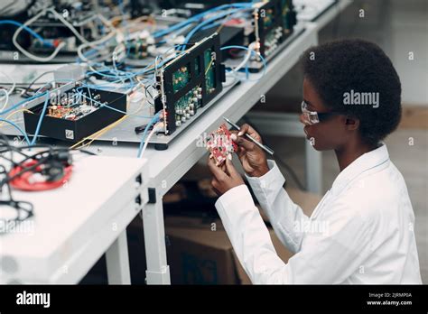 Scientist African American Woman Working In Lab And Single Photon Decoder Encoder Fiber Optic