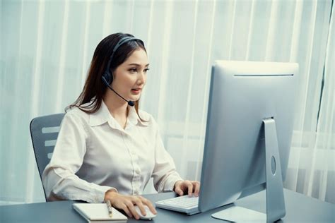 Premium Photo Enthusiastic Asian Call Center With Headset And Microphone Working On Her Laptop
