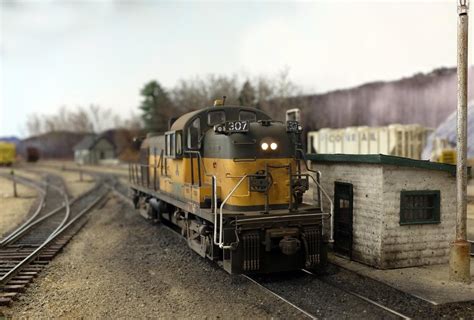 Model Train Passing Small Building
