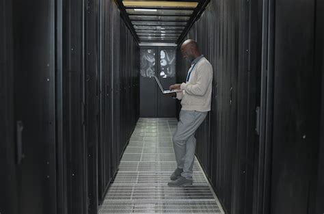 Premium Photo Laptop Network And Data Center With It Black Man For Research Engineer Working