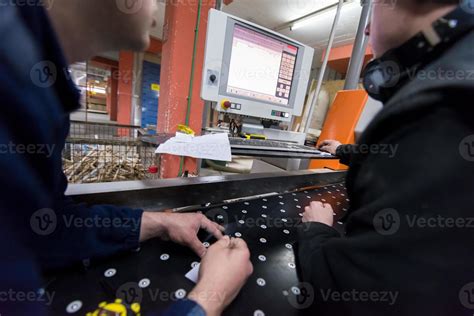 Carpenters Calculating And Programming A Cnc Wood Working Machine Stock Photo At Vecteezy