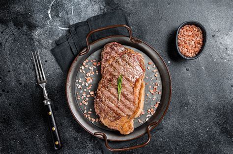 바비큐 그릴 스트립에인 또는 분홍색 소금과 허브를 곁들인 뉴욕 소고기 고기 스테이크 검은 색 배경 위쪽 보기 안심 스테이크에 대한 스톡 사진 및 기타 이미지 Istock