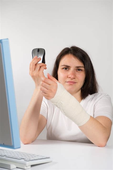 A Woman With An Elastic Bandage On Her Wrist Sits In Front Of A Computer Carpal Tunnel Syndrome