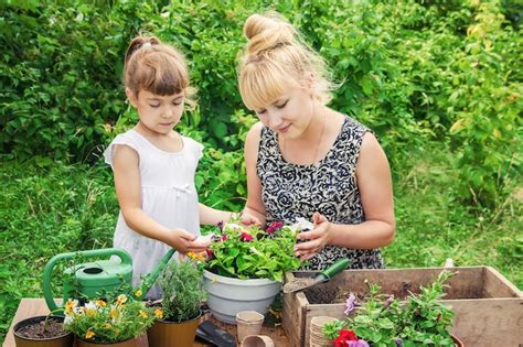 Premium Photo Portrait Of Smiling Girl Picking Plants