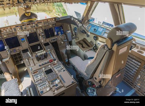 A View Of Cockpit Of A 747 8f Aircraft With Captain Hat On The Avionics